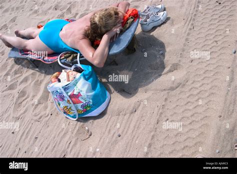 Woman At The Beach Lying Face Down On A Folding Chair Stock Photo Alamy