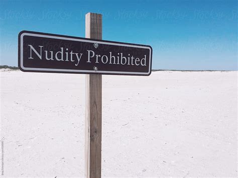 Nudity Prohibited Sign On A Deserted Beach In The Warm Summer Sun By