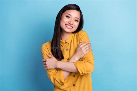 Photo Of Young Asian Girl Happy Positive Smile Hug Cuddle Herself Comfort Soft Isolated Over