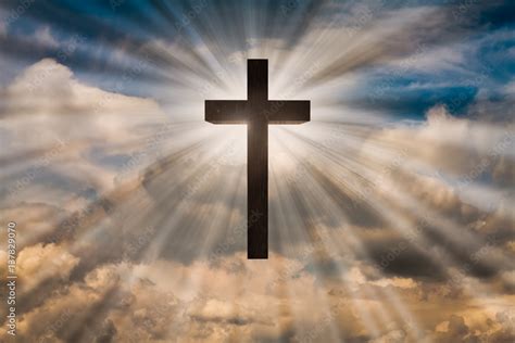 Jesus Christ Cross On A Sky With Dramatic Clouds And Bright Sun Rays