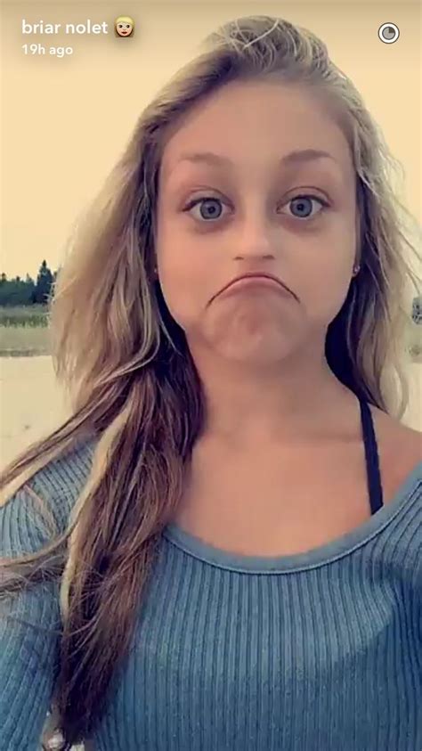 A Woman Making A Face While Standing In Front Of The Camera With An