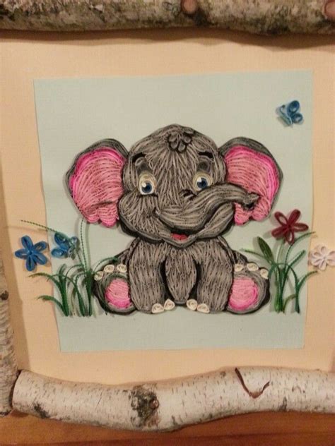 An Elephant With Pink Tusks Sitting On Top Of A Tree Branch Next To Flowers