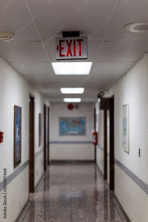 Red Emergency Exit Sign In The Dark Room Illuminated Office Exit Sign