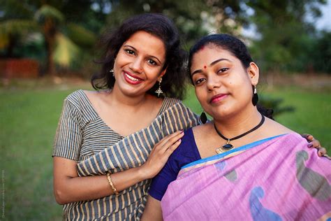 Two Indian Woman Wearing Sari And Holding Each Other By Stocksy