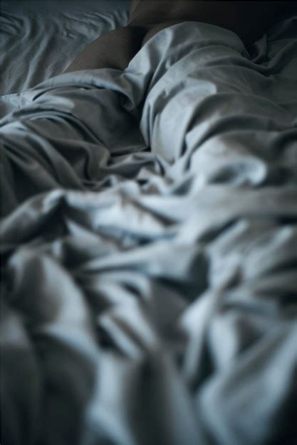 Premium Photo Midsection Of Naked Person Lying On Bed