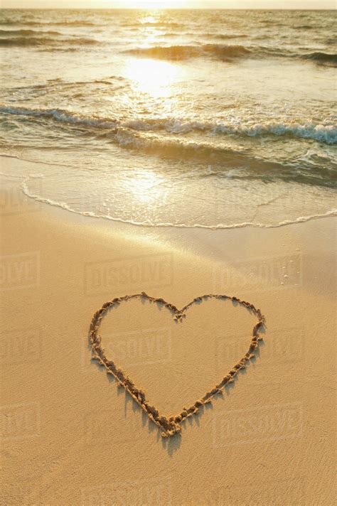 Heart Drawn In Sand On Beach Stock Photo Dissolve
