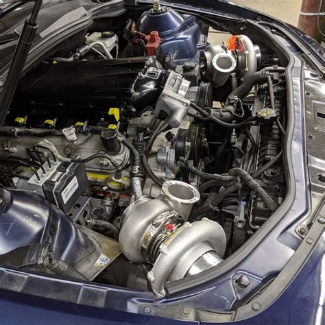 The Engine Compartment Of A Blue Car With Its Hood Open