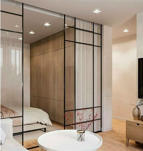 The Room Is Decorated In White And Has Glass Partitions To Divide It