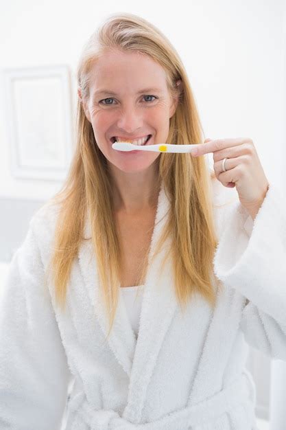 Premium Photo Happy Blonde Brushing Her Teeth