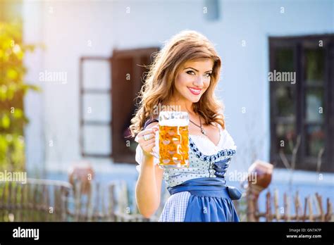 Woman In Traditional Bavarian Dress Holding Mug Of Beer Stock Photo Alamy