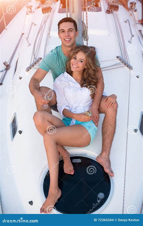 Couple On Yacht Hugging Sailing At Seaside Enjoying Vacation Vertical Stock Image