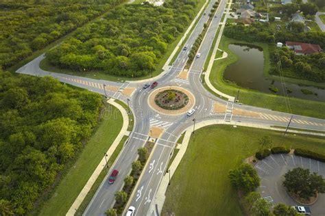 Aerial View Of Road Roundabout Intersection With Moving Cars Traffic