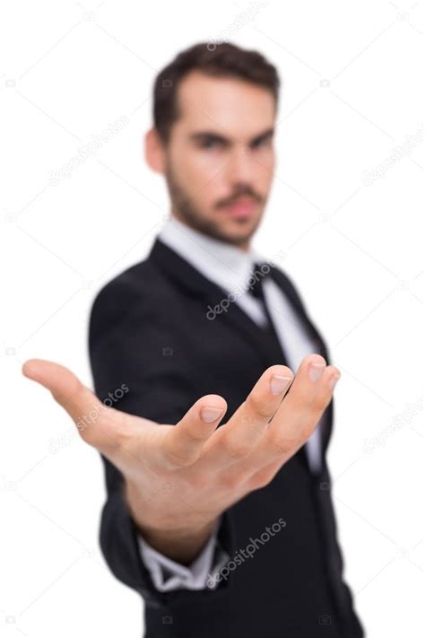 Businessman Holding Hand Out In Presentation Stock Photo By