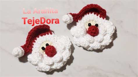 Two Crocheted Santa Clauss Are Sitting On A Marble Surface With The