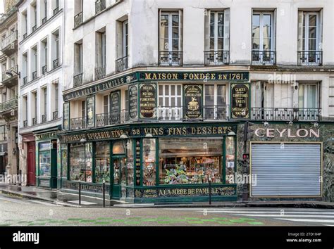 The green and gold exterior of À La Mère de Famille the oldest