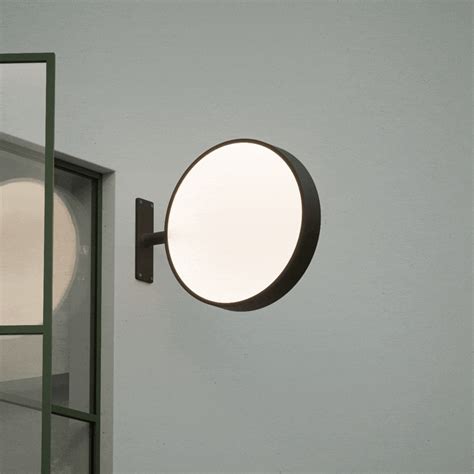 A Round Light Mounted To The Side Of A Wall