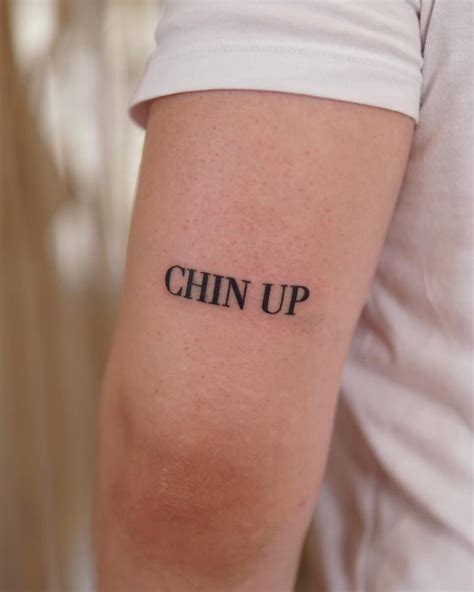 Hand Poked Lettering Tattoo That Says Chin Up Located