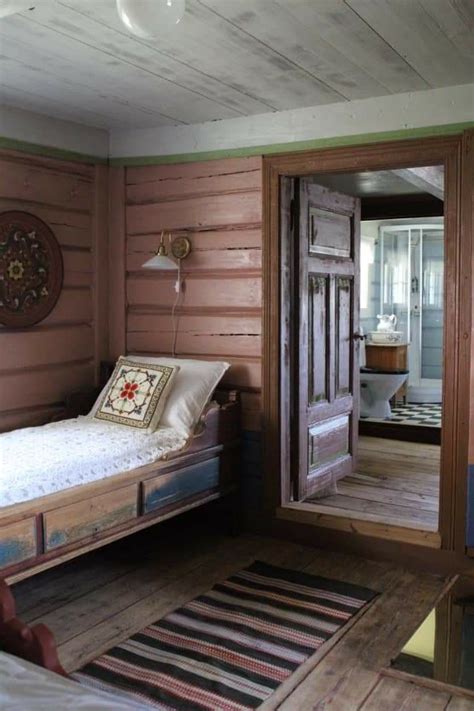 A Bedroom With Wood Paneling And A Bed In The Corner Next To An Open Door