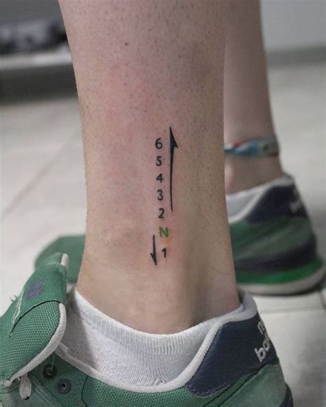 A Person With A Tattoo On Their Foot