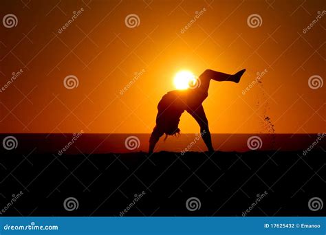 Silhouette Of Gymnast On Beach At Sunset Stock Photo Image 17625432