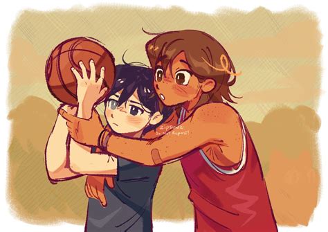 Two People Hugging Each Other While Holding A Basketball