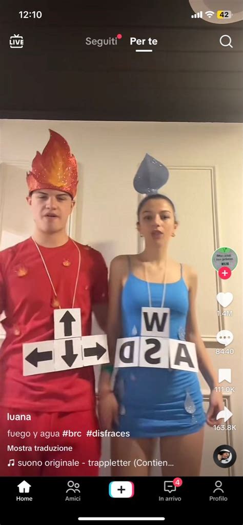 Two People Dressed Up In Costumes Standing Next To Each Other With