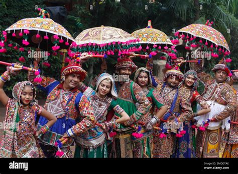 Indian Men And Women In Traditional Attire Pose For Photographs As They