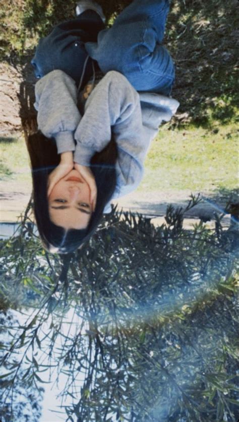 A Person Upside Down In The Grass With Their Hands On Their Hips And