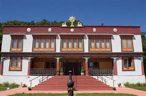 A Large White Building With Red And Yellow Trim On It S Windows Steps