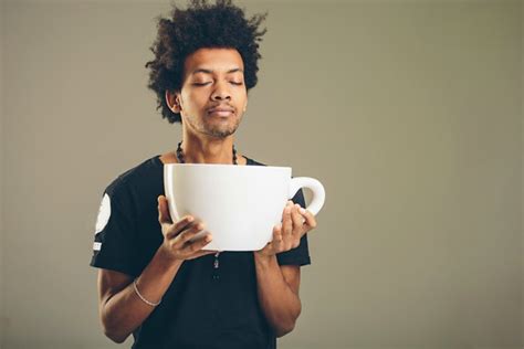Man Holding Comically Large Cup Of Coffee Positive Routines