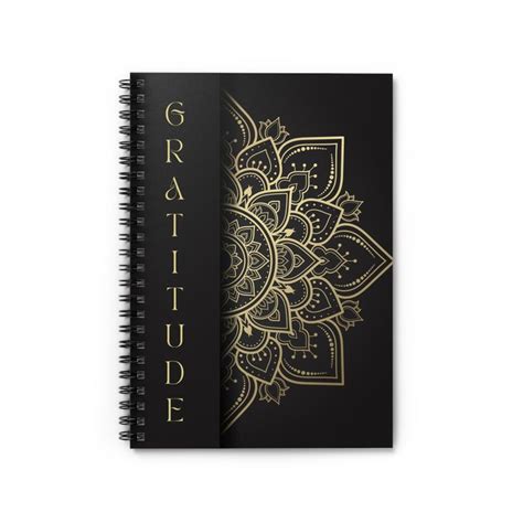 A Spiral Notebook With The Word Gratie Written In Gold Foil On Black Paper