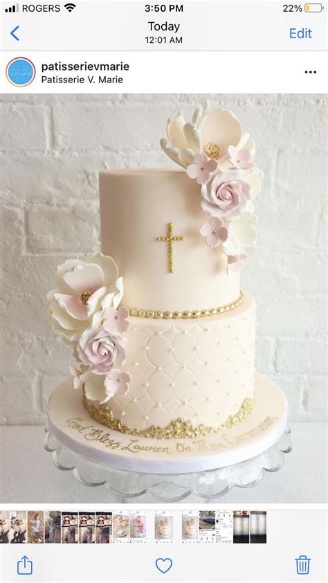 A Three Tiered White Wedding Cake With Pink Flowers On The Top And Gold