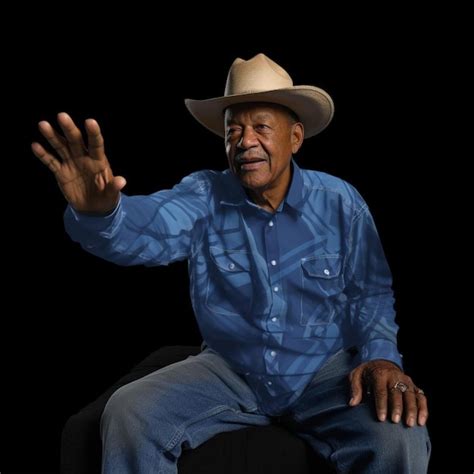 Premium Photo A Man Wearing A Cowboy Hat Is Sitting In A Chair
