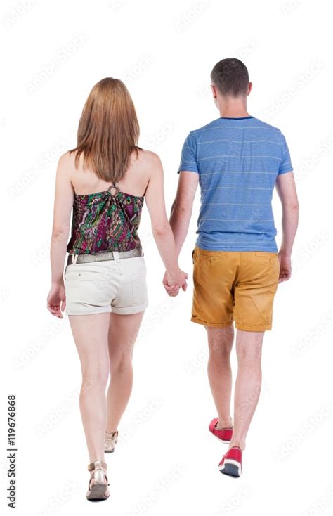 Back View Going Couple In Shorts Walking Friendly Girl And Guy Holding