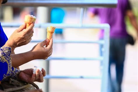 Premium Photo Cropped Hands Of Woman Holding Ice Cream Cone