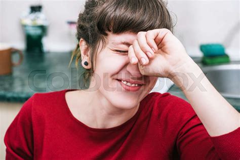 Woman Covering Her Face Laughing In The House Stock Image Colourbox