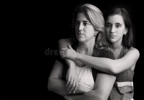 Madre Triste Y Enojada Con La Hija Que La Abraza Imagen De Archivo