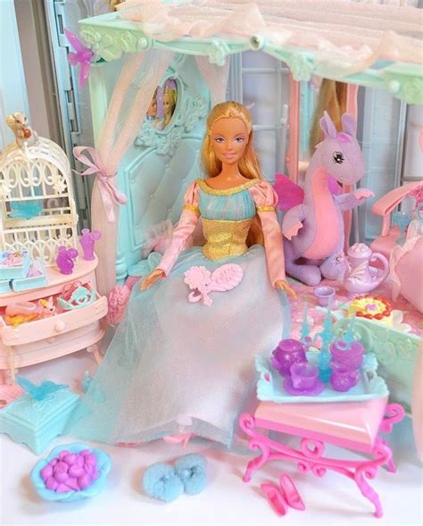A Barbie Doll Sitting In A Bed With Other Toys