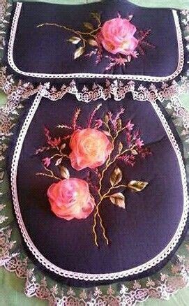 Two Black Place Mats With Pink Flowers On Them And Lace Trimmings