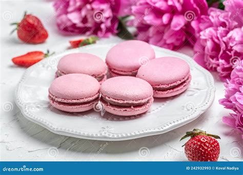 Pink Macaron Or Macaroon Cakes With Peony Rose On A White Background