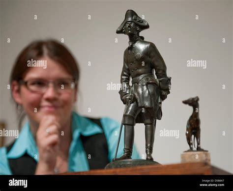 A Female Visitor Examines A Sculpture Made Of Bronze By German Artist
