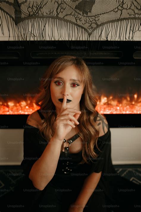 A Woman Sitting In Front Of A Fire Place Photo Portrait Image On Unsplash