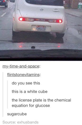 A White Car Driving Down A Rain Soaked Street