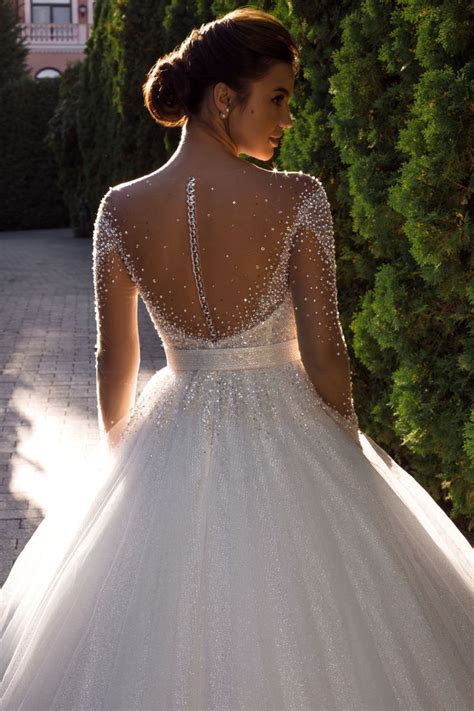 A Woman In A White Wedding Dress Standing Outside