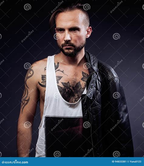 A Man With Tattooes On His Arms Silhouette Of Muscular Body Stock