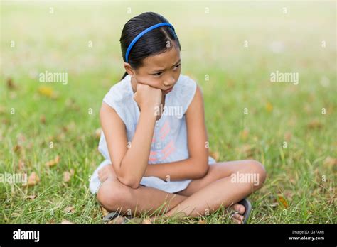 Upset Girl Sitting On Grass Stock Photo Alamy