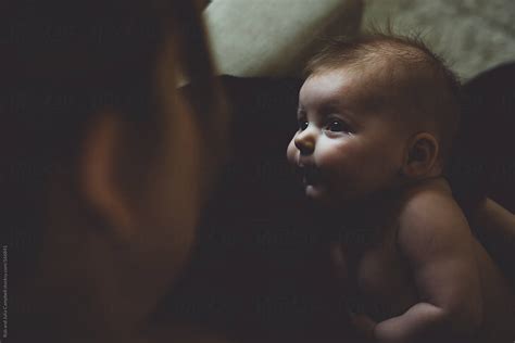 Close Up Of Mother And Cute Naked Baby Girl With Blue Eyes By Stocksy