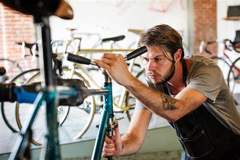 A Man Working In A Bicycle Repair Shop Stock Image F016 4534