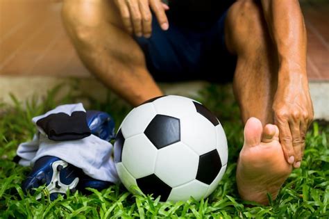 Premium Photo Low Section Of Man Playing Soccer Ball On Grass
