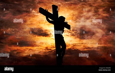 Jesus Christ Crucified On The Cross At Calvary Hill With Burning Sky In